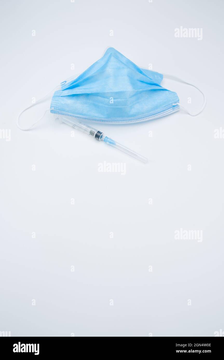 Isolated blue respiratory mask and syringe on a white background Stock ...