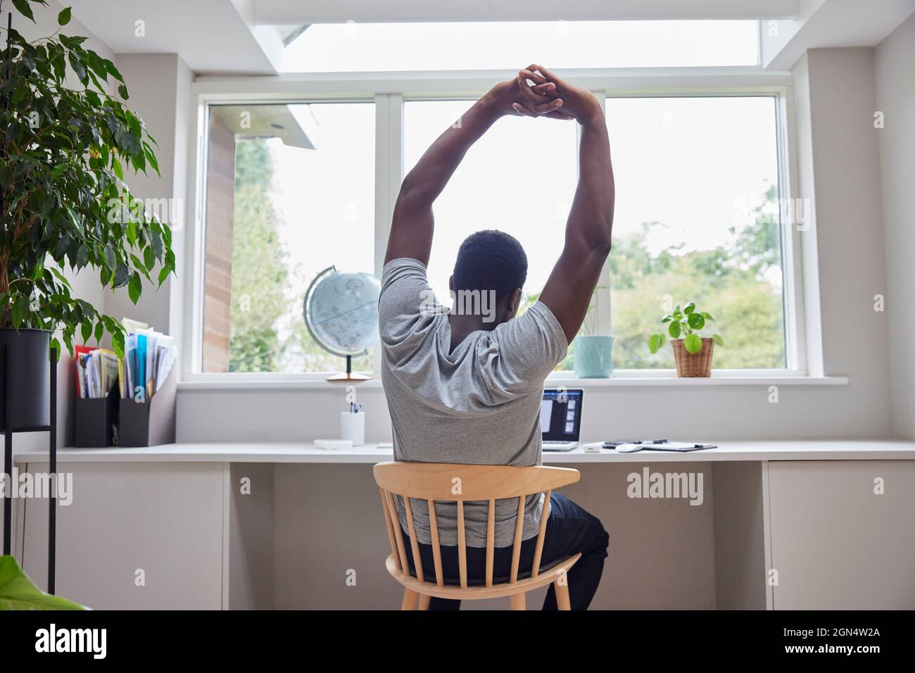 Rear View Of Man Working From Home On Computer In Home Office ...