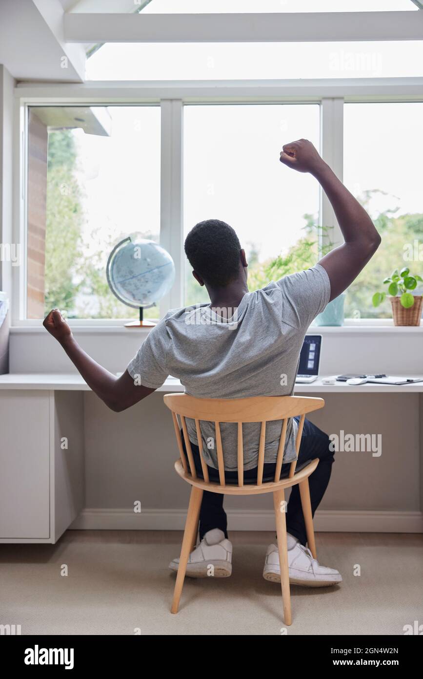 Rear View Of Man Working From Home On Computer In Home Office ...