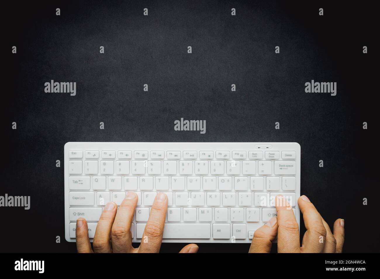 hands typing on a white computer keyboard, Black background, Place for an inscription Stock ...