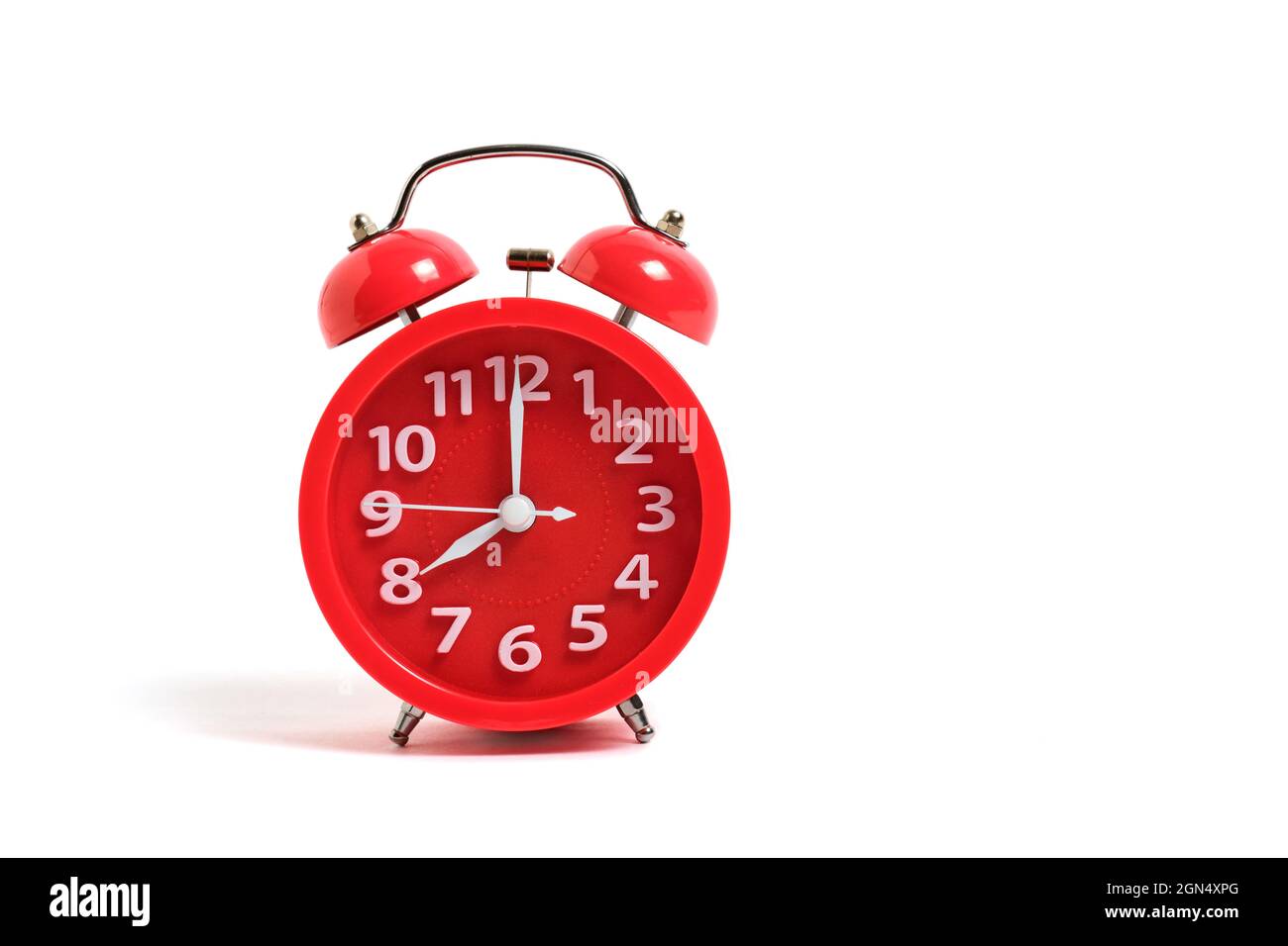Red alarm clock isolated on a white background shows eight clock in ...