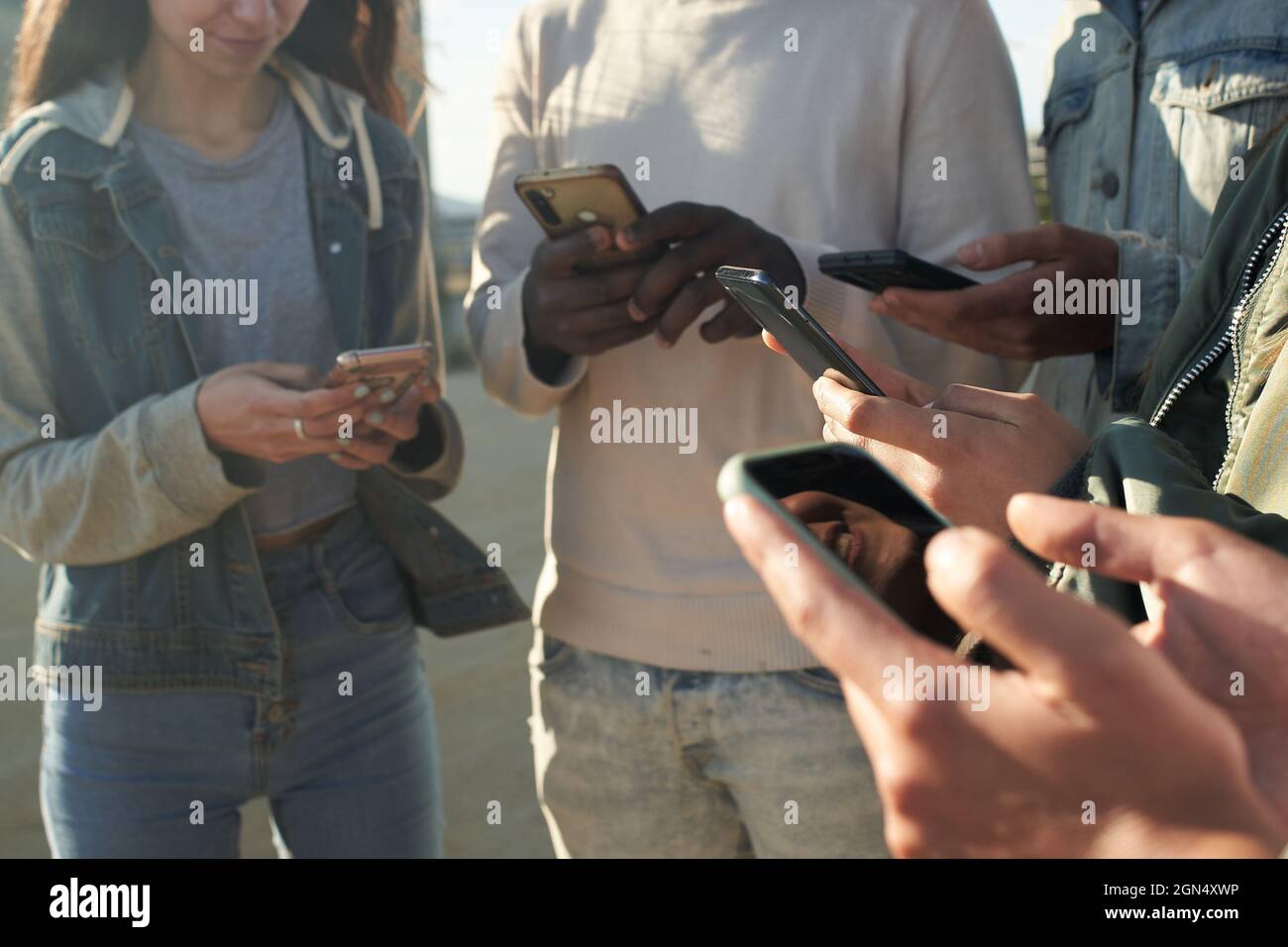 Group of unrecognizable people using and looking al mobile phone ...