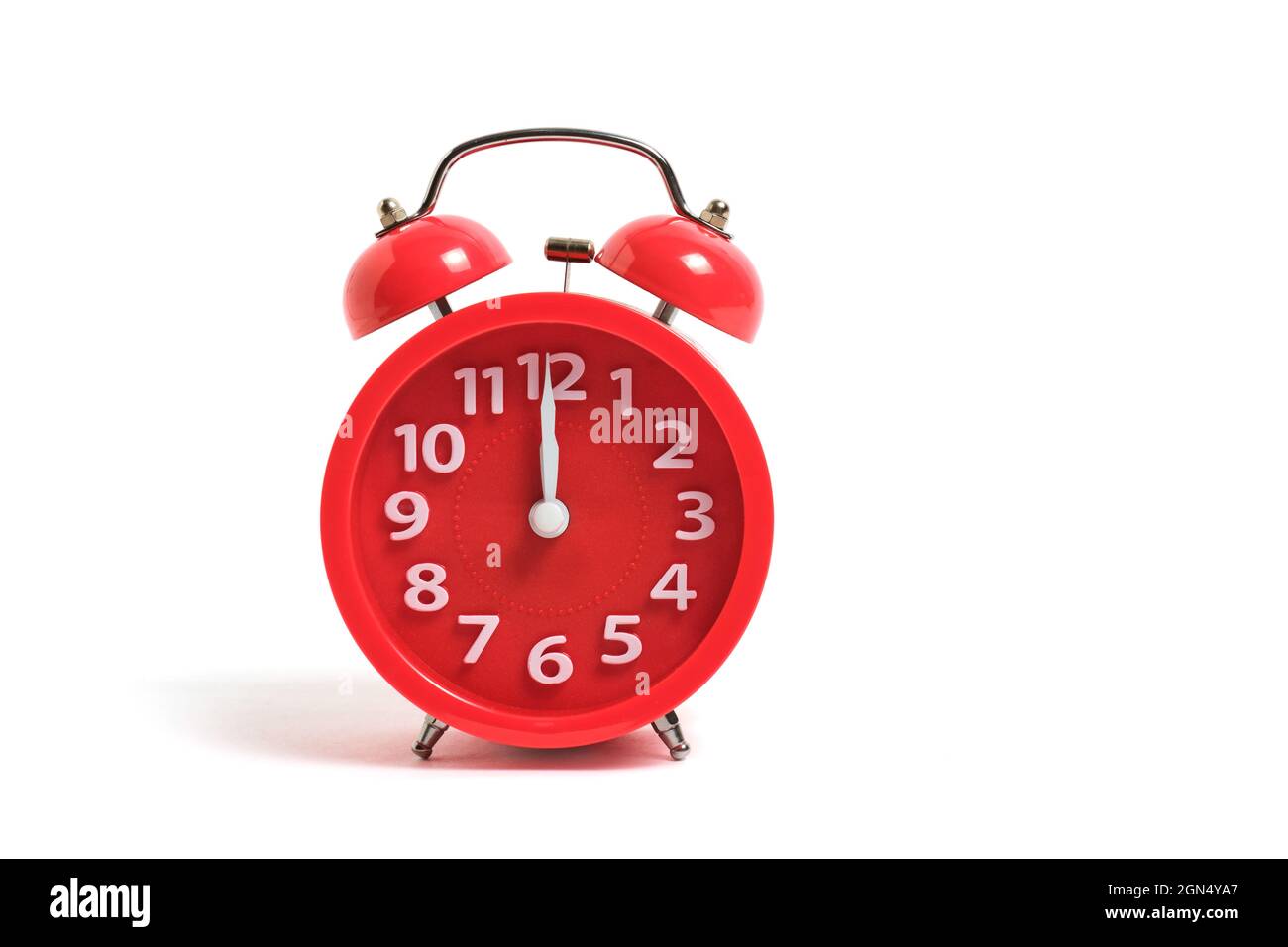 Red alarm clock is isolated on a white background, shows twelve clock ...