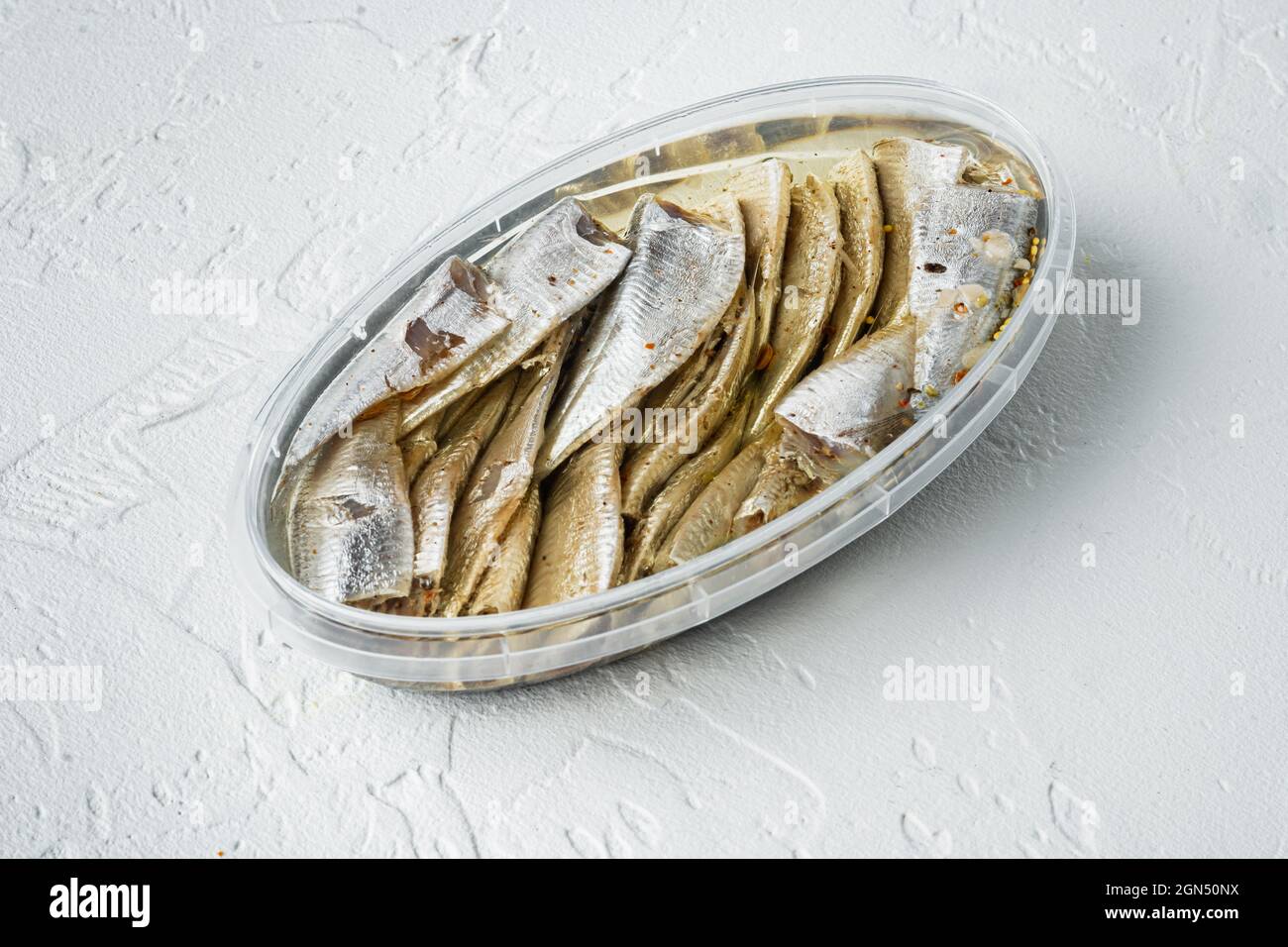 Pickled Anchovy set, in plastic container, on white background Stock ...