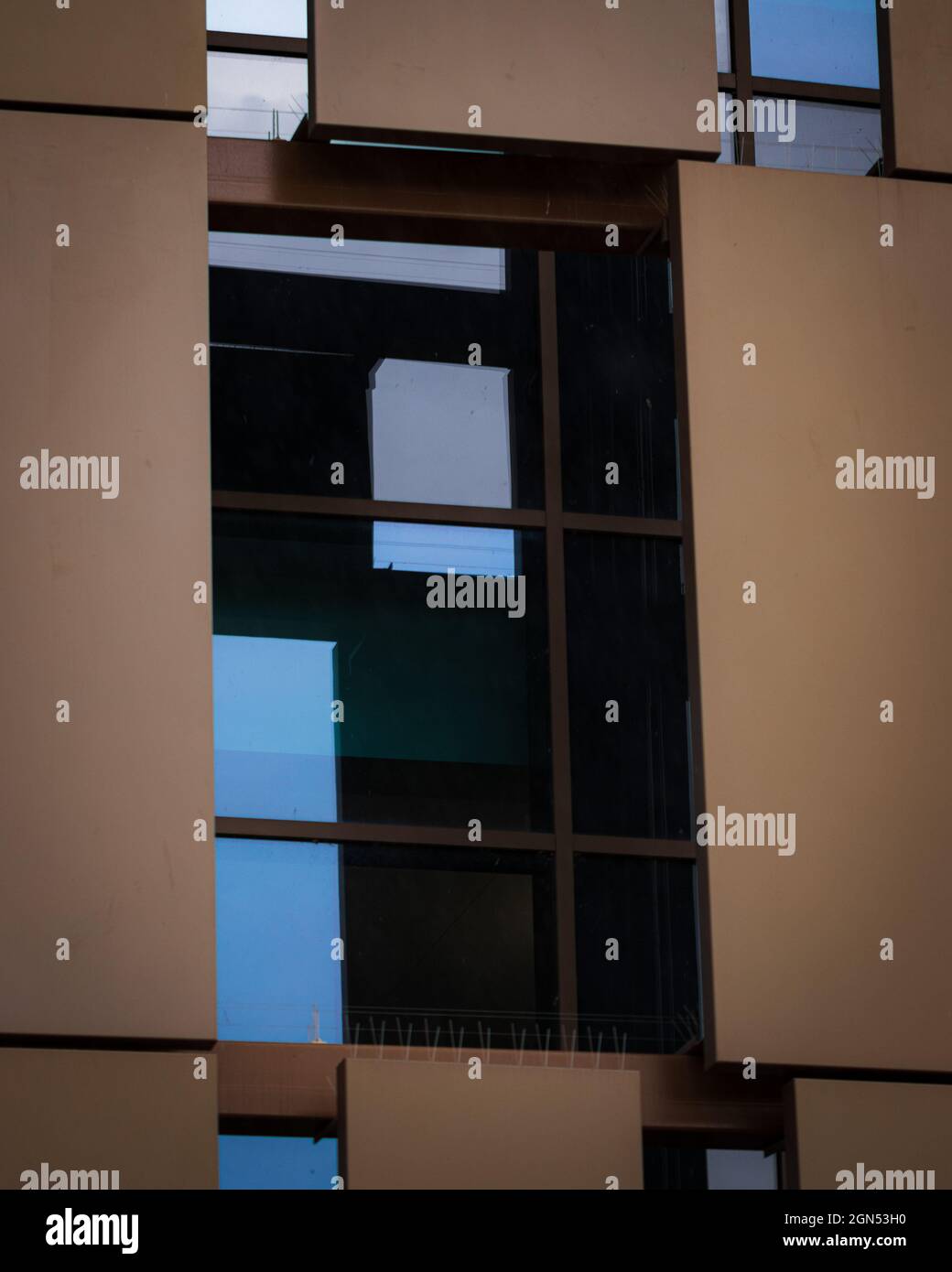 Vertical shot of a building with glass windows Stock Photo - Alamy