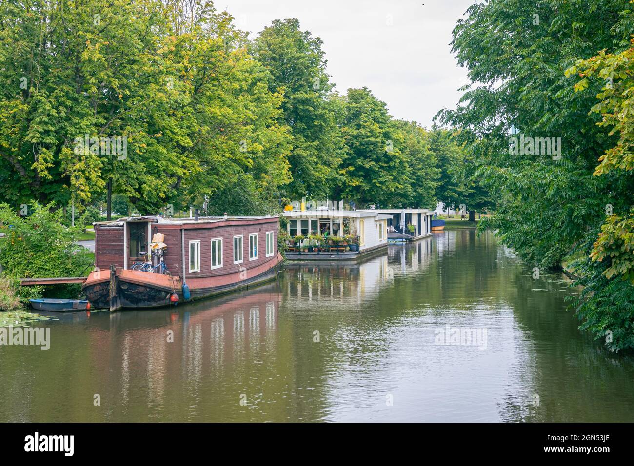 Scenic view of houseboats in a canal in the city of Leiden, The ...