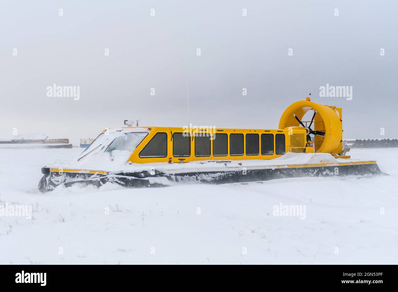 Hovercraft in winter tundra. Air cushion on the beach. Yellow hover ...
