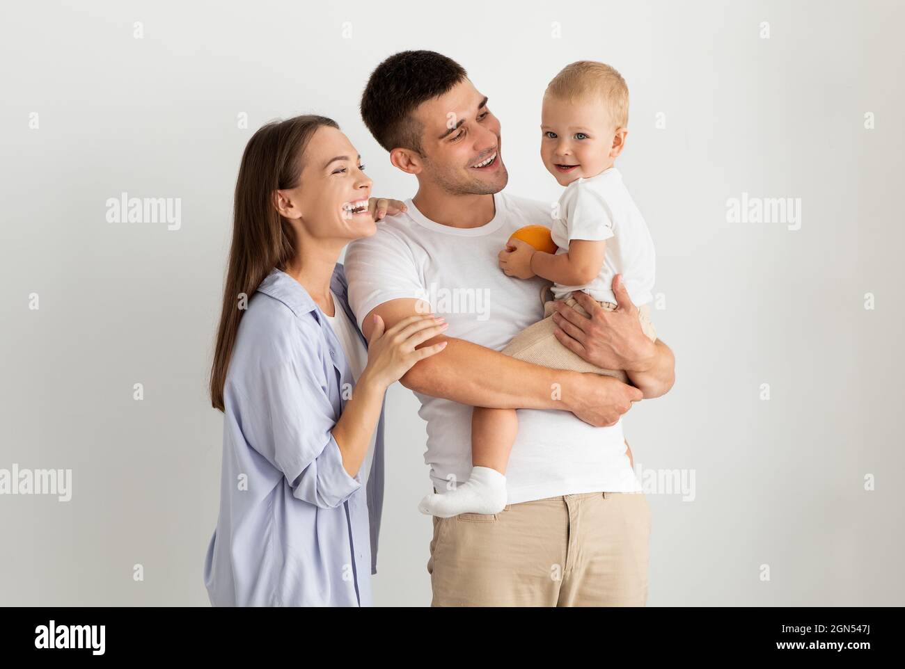 Happy Family Of Three With Cute Infant Baby Posing Over White ...