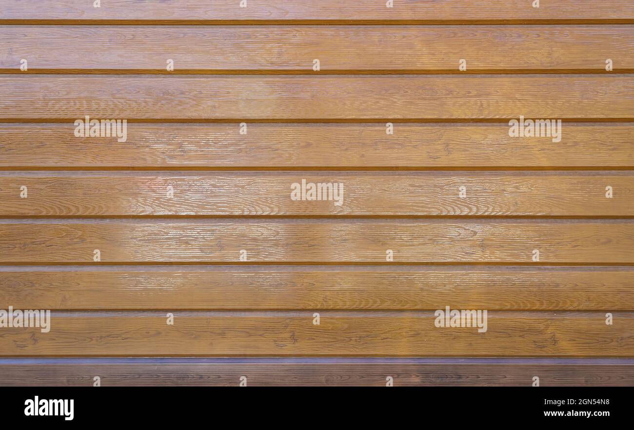 The brown wall of a residential building made of square timber. Texture ...