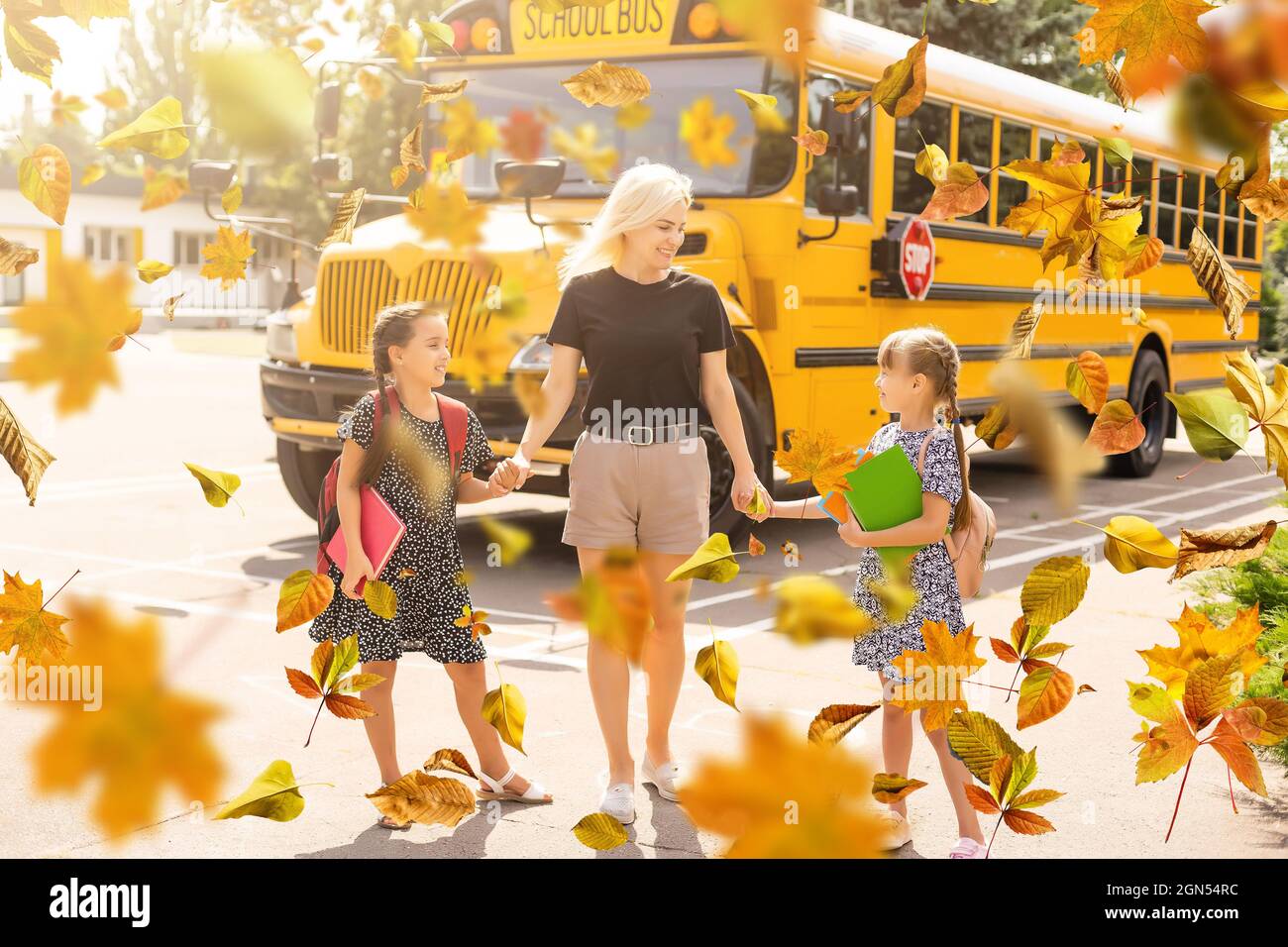 Happy Caucasian children elementary student running by yellow bus on ...