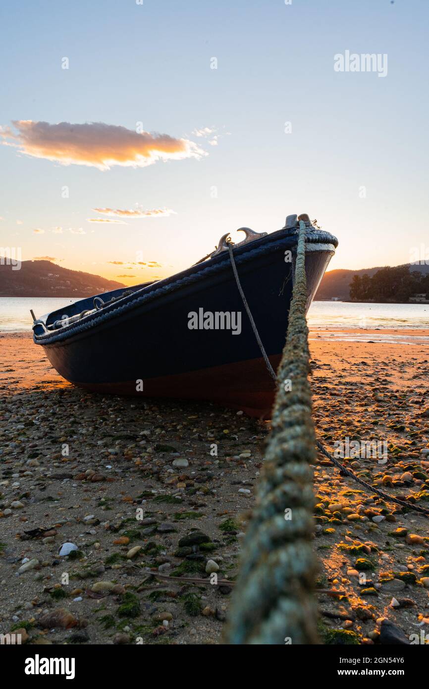 Boat beached on the sand of the beach Stock Photo - Alamy