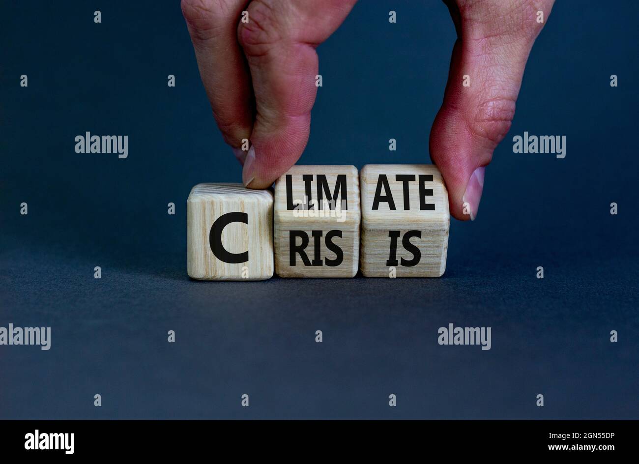 Climate crisis and change symbol. Businessman turns wooden cubes with ...