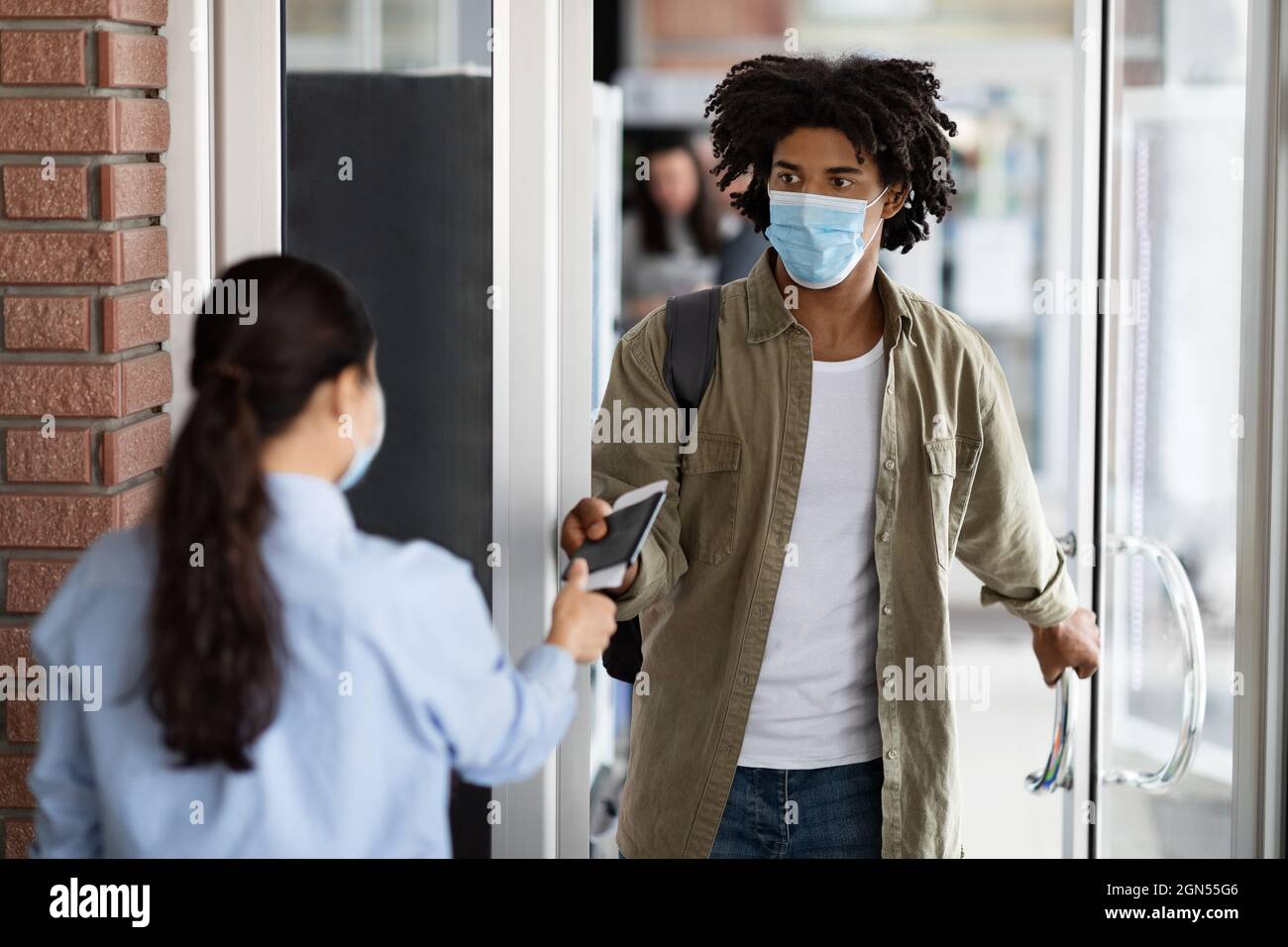 Black Traveller In Mask Giving Passport And Tickets For Checking At ...
