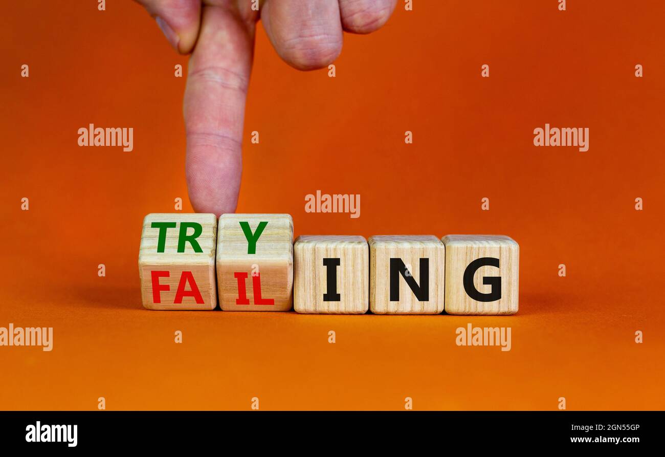 Failing or trying symbol. Businessman turns wooden cubes and changes ...
