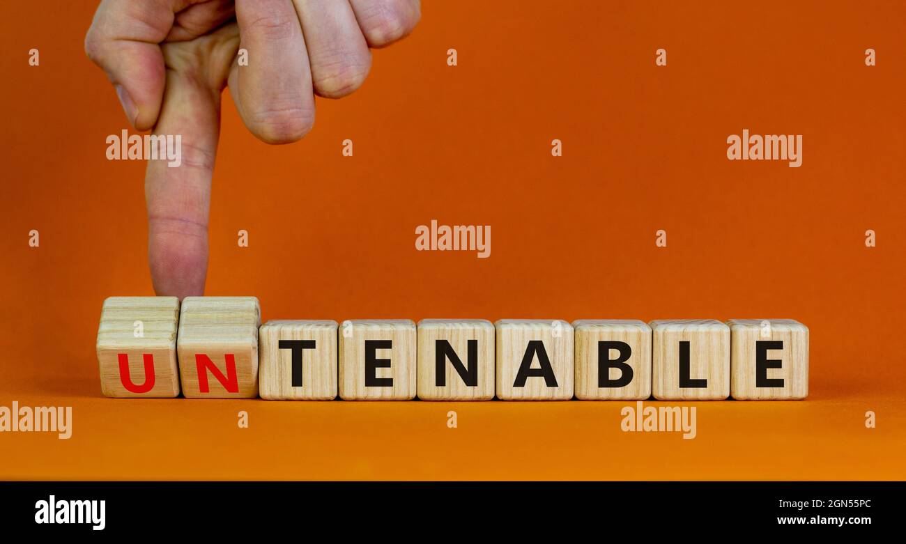 Tenable or untenable symbol. Businessman turns cubes and changes the ...