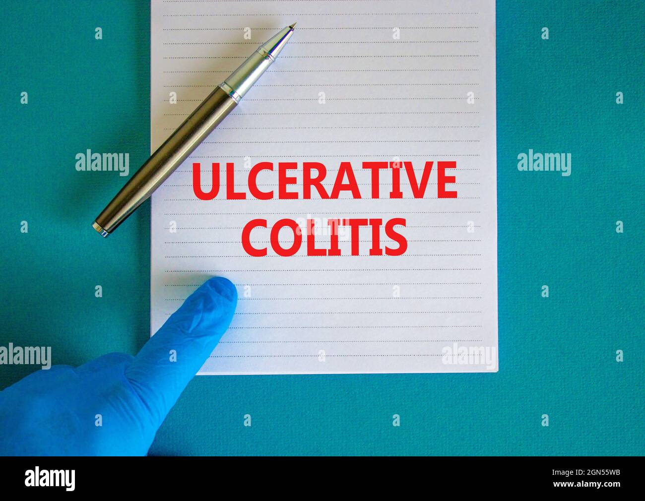 Ulcerative colitis symbol. White note with words Ulcerative colitis ...