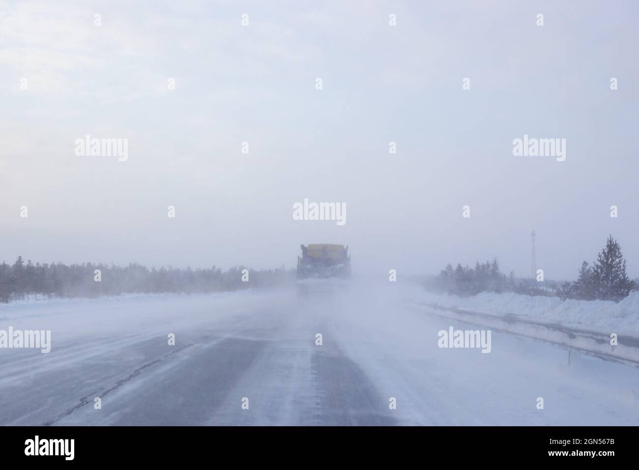 cars go on a winter road with poor visibility, weather and snowstorm ...