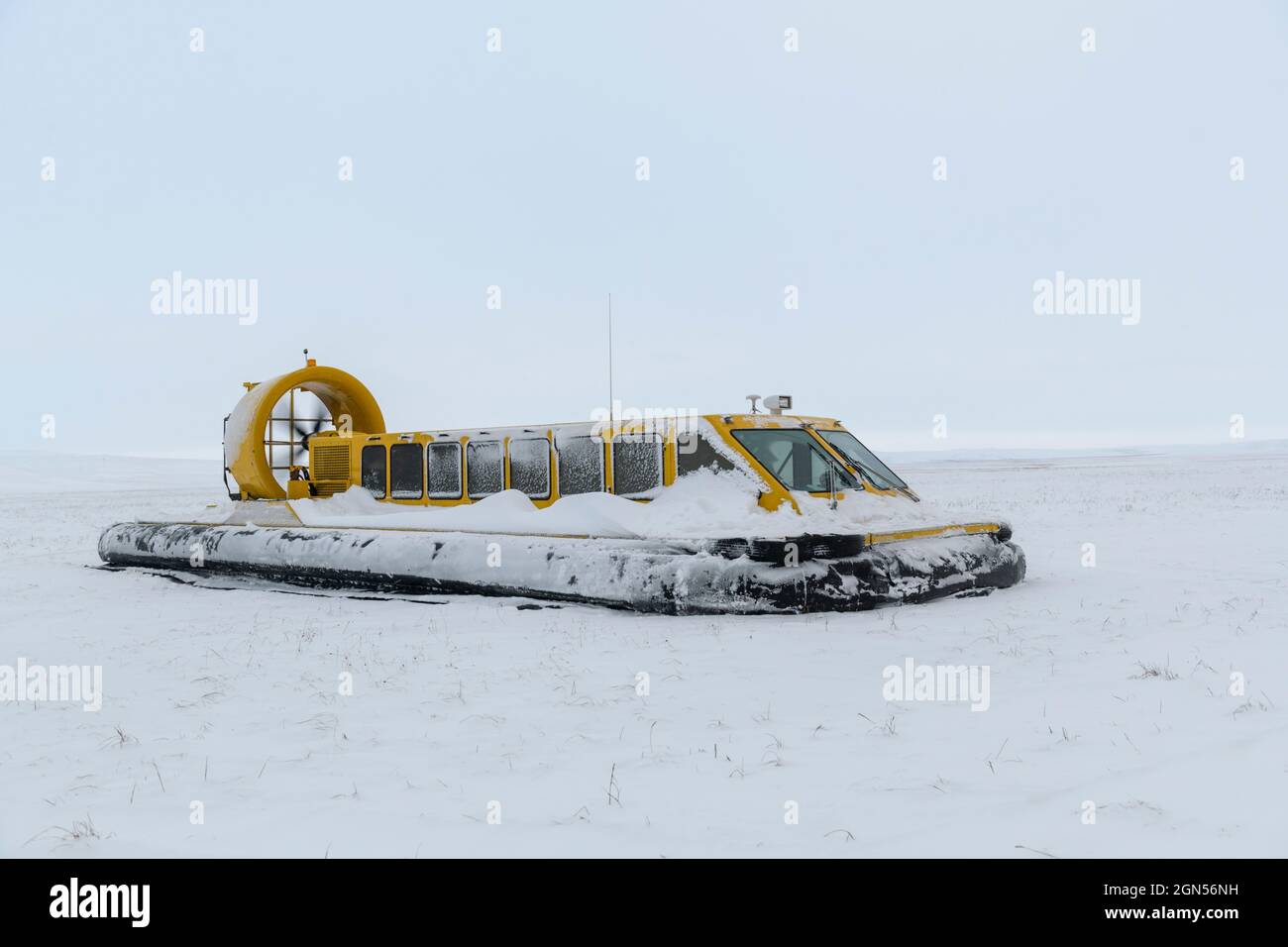 Hovercraft in winter tundra. Air cushion on the beach. Yellow hover ...