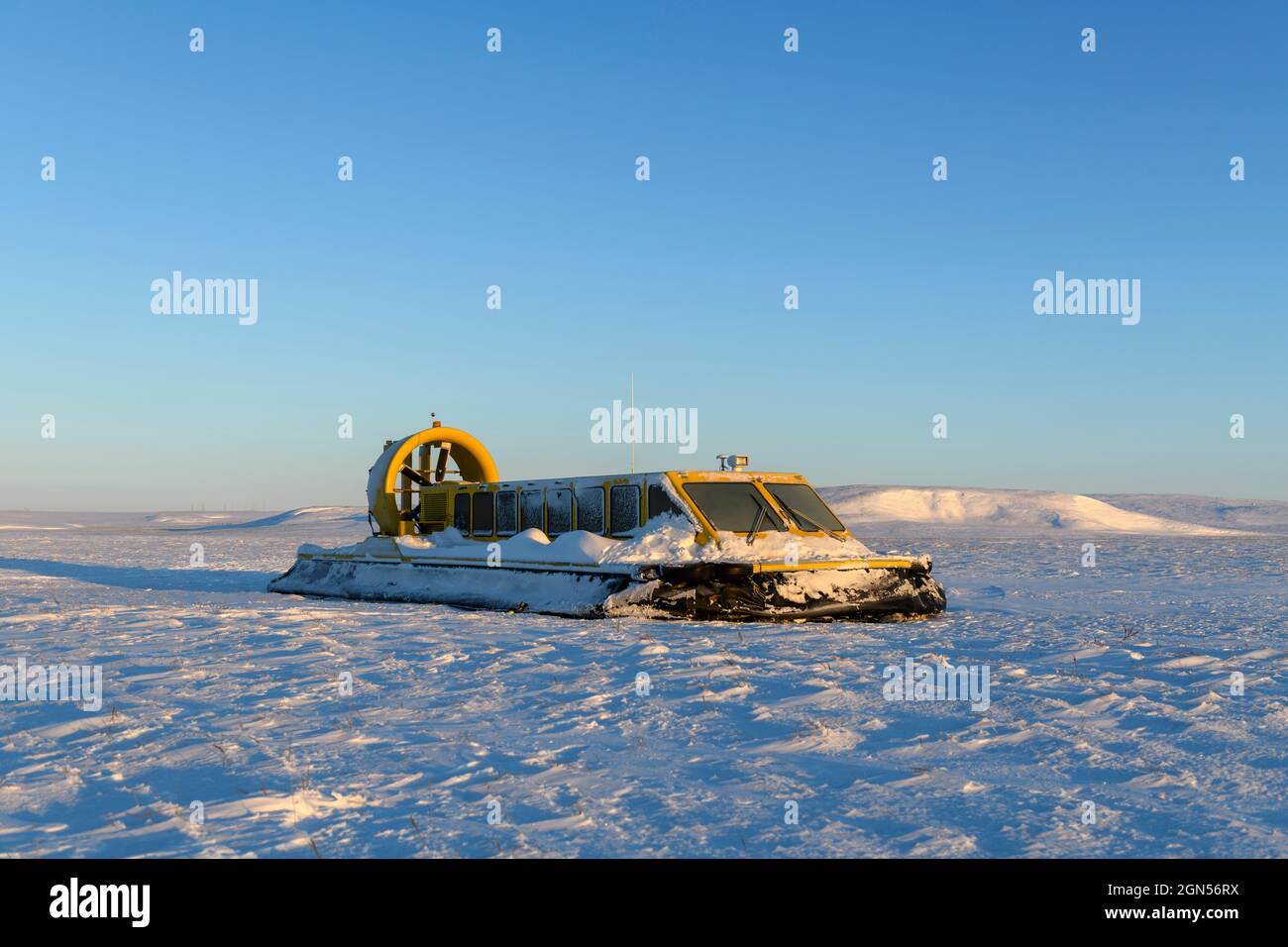 Hovercraft in winter tundra. Air cushion on the beach. Yellow hover ...