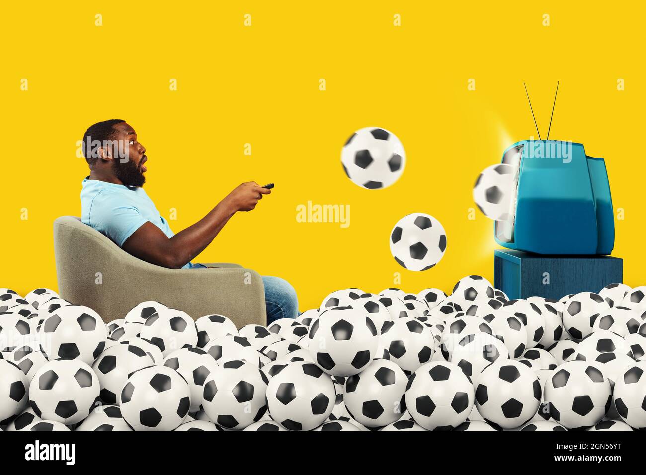 Shocked soccer viewer submerged by soccer balls coming out of TV Stock ...