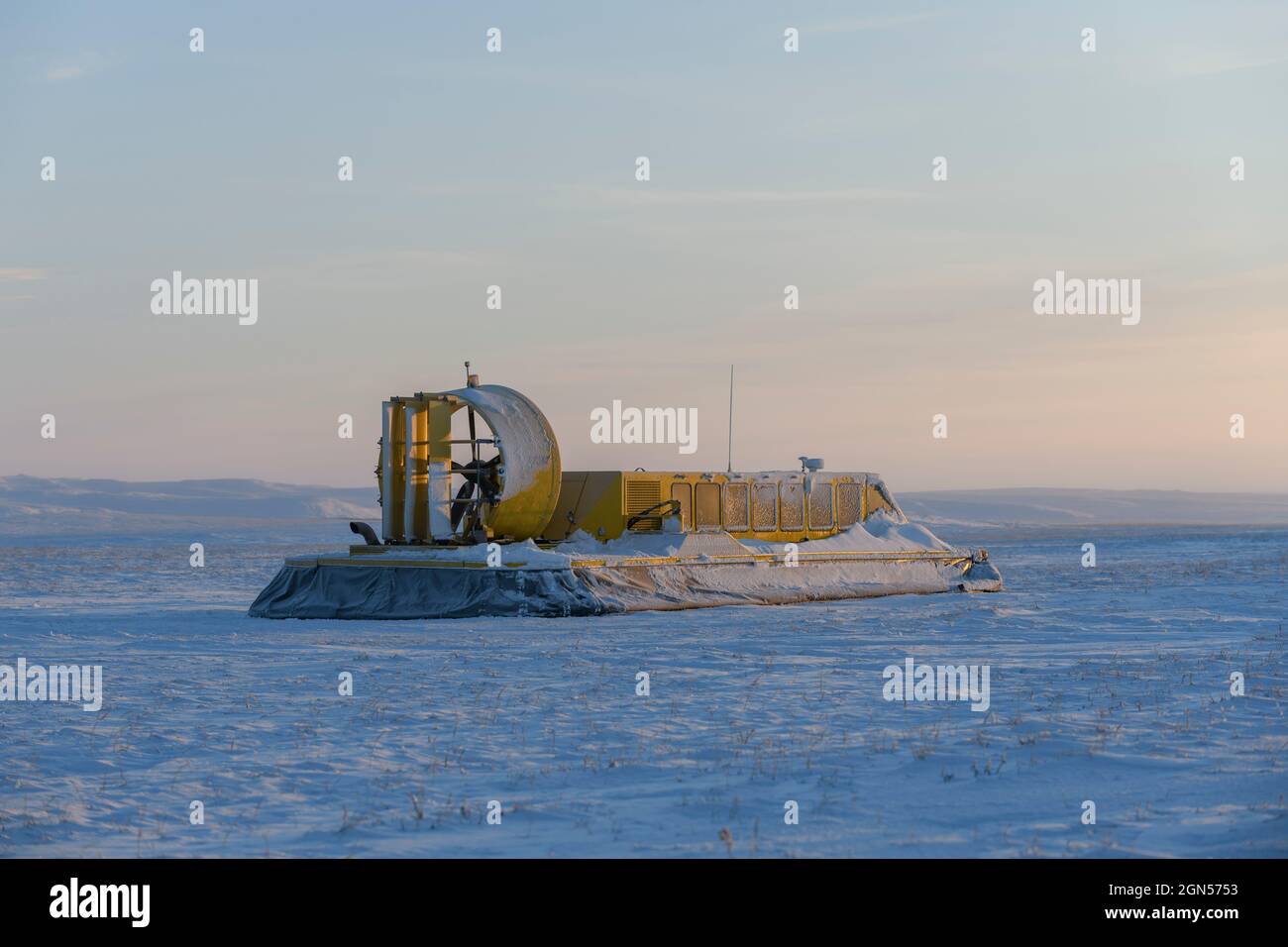 Hovercraft in winter tundra. Air cushion on the beach. Yellow hover ...