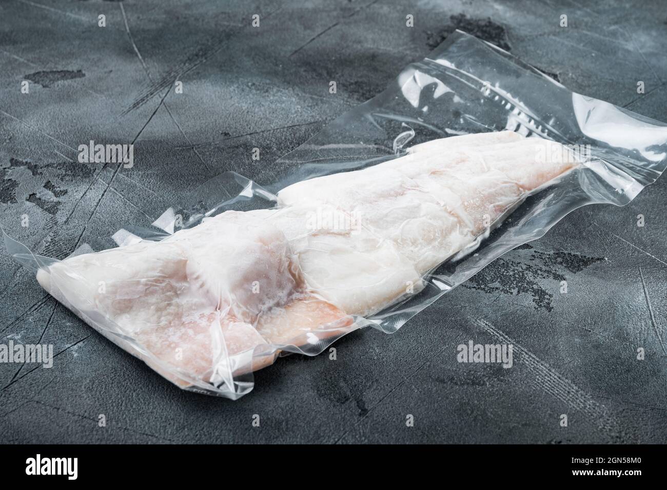 Haddock white fish fillet in plastic market package, on gray background ...