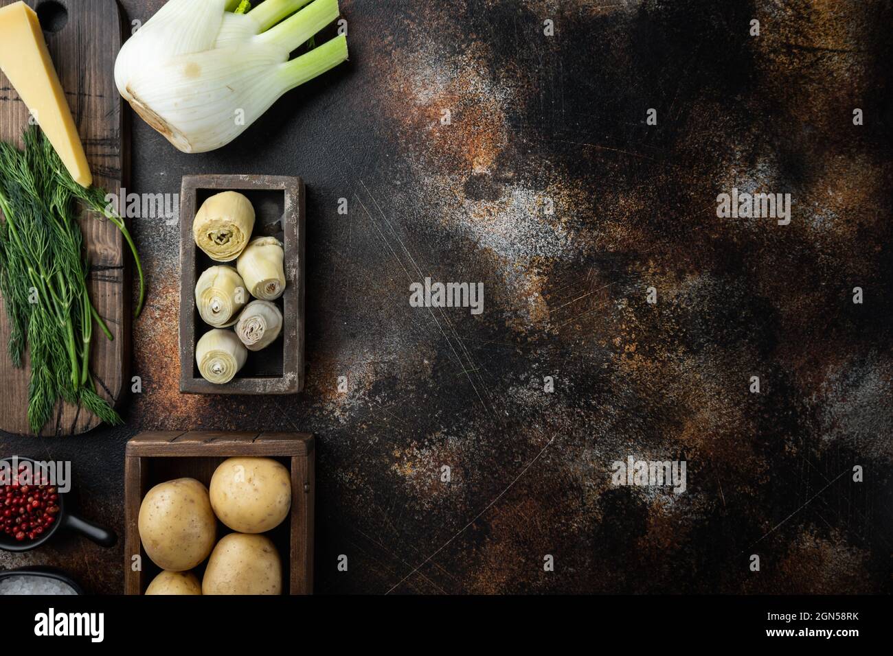 Potato and artichoke al forno ingredient, on old rustic background, top ...