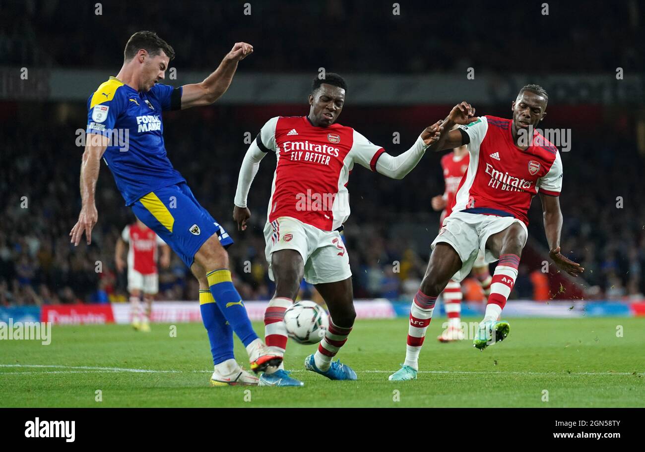 AFC Wimbledon's Ben Heneghan (left) in action with Arsenal's Eddie ...