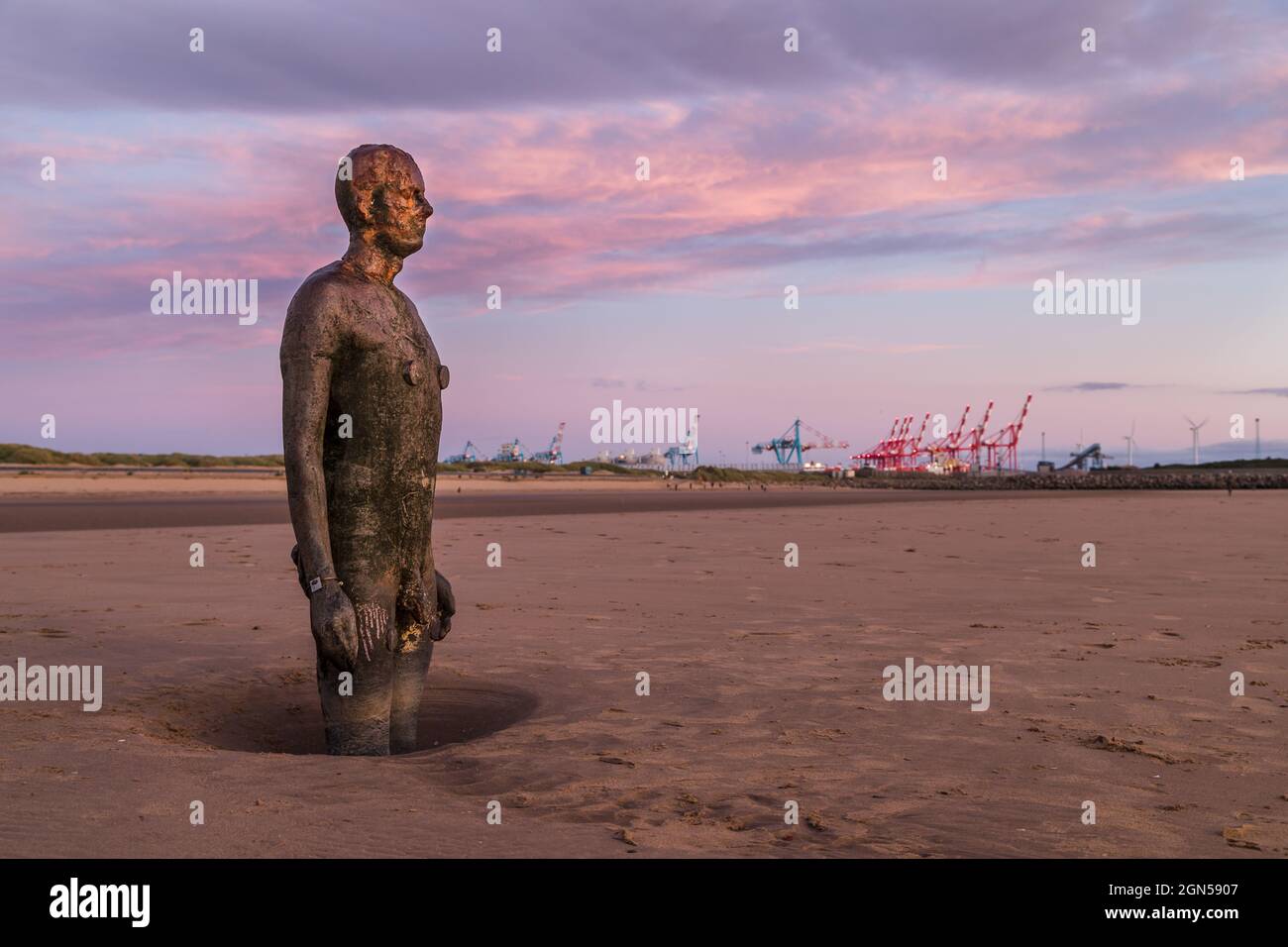 High cloud above an Iron Man lit up in pink and puple light at sunset ...