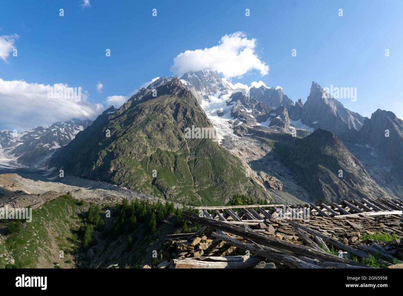 Collapsed roof of abandoned hut in the mountains. Beams of woods left ...