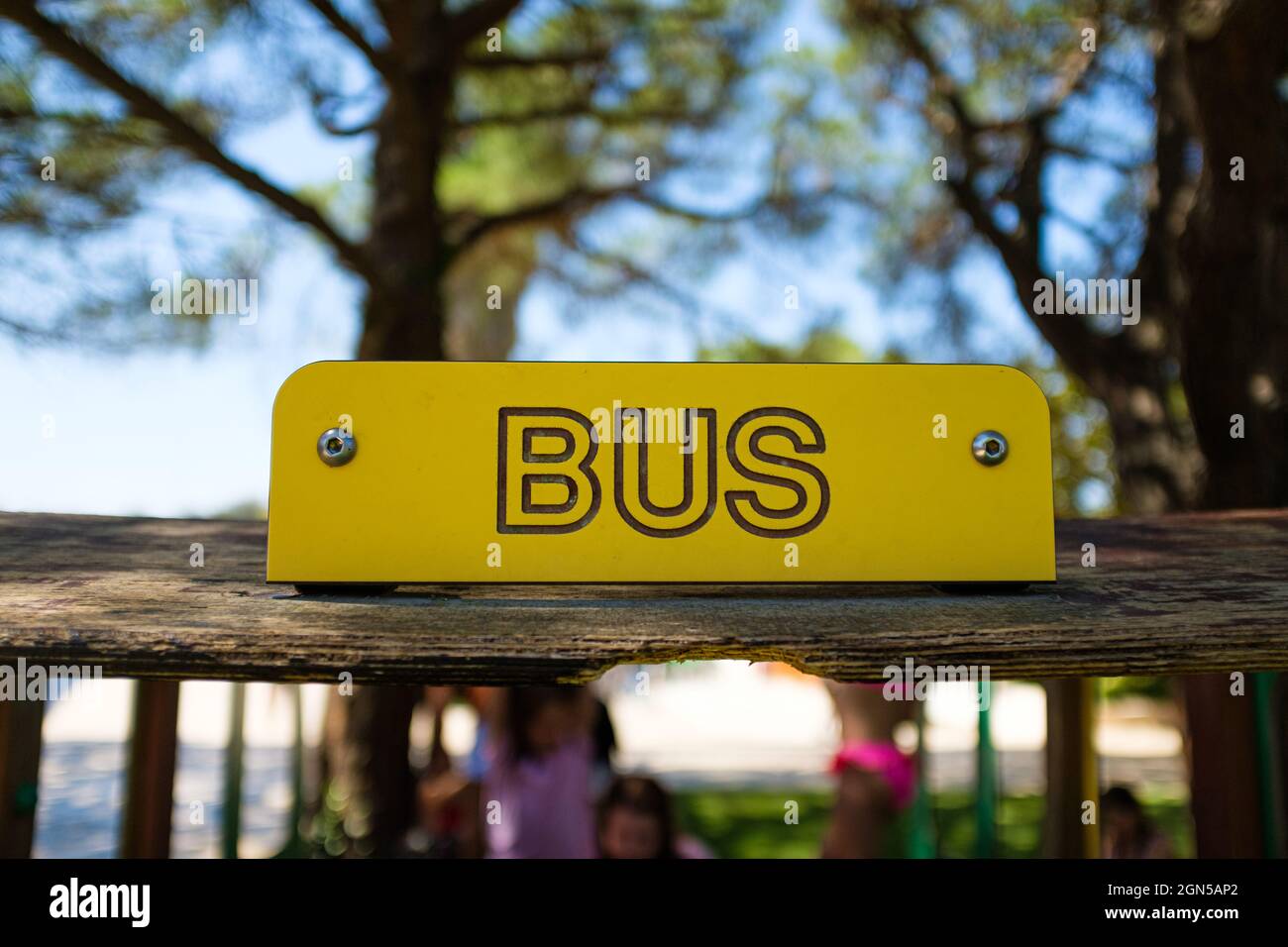 Yellow bus vehicle logo on a blurry background Stock Photo - Alamy