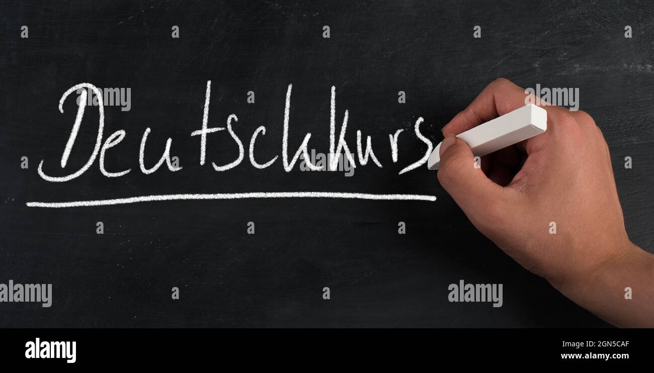 The words german lesson is standing on a blackboard Stock Photo - Alamy