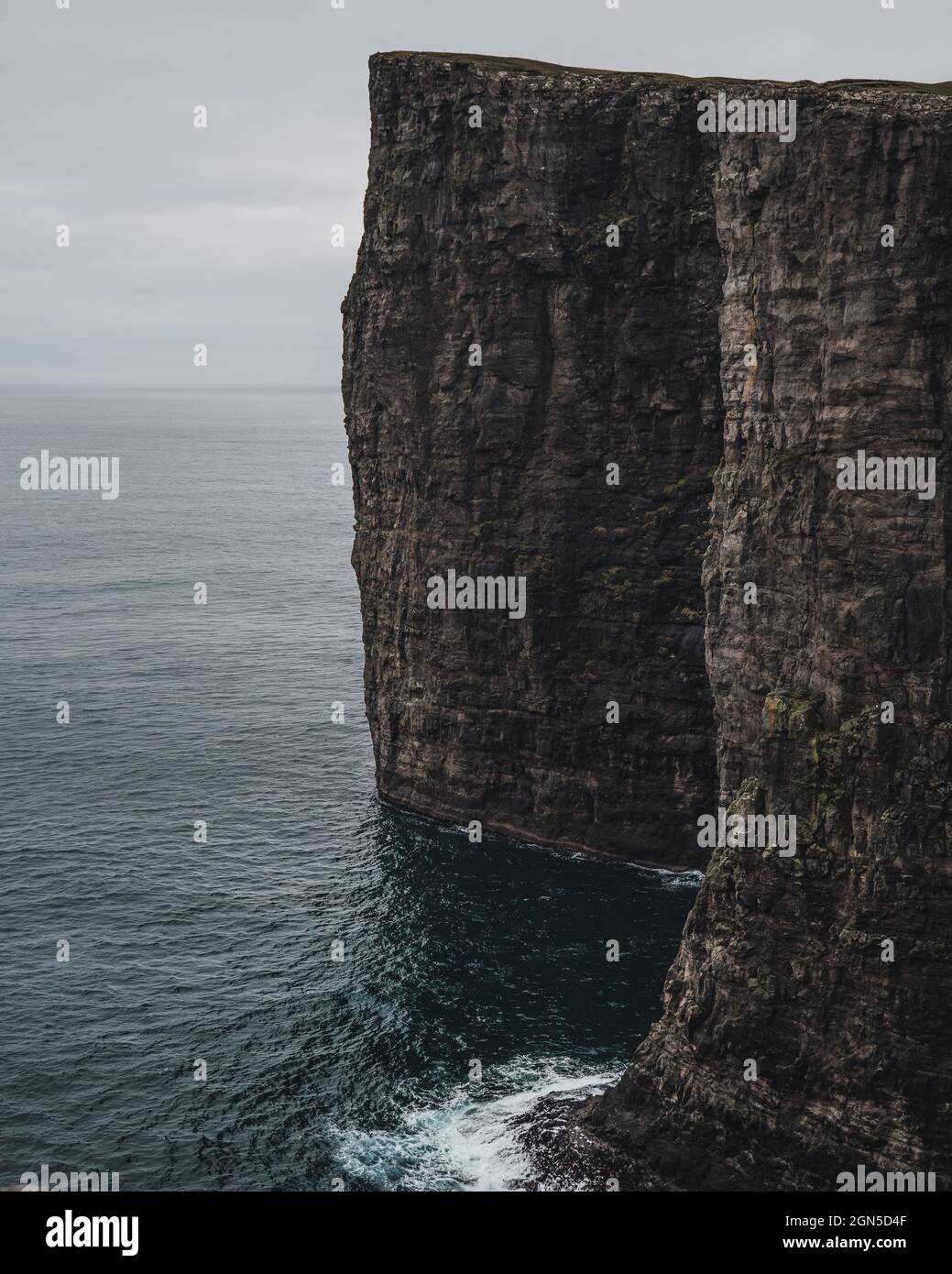 Black cliffs formation in the Atlantic ocean, Faroe Islands. Towering ...