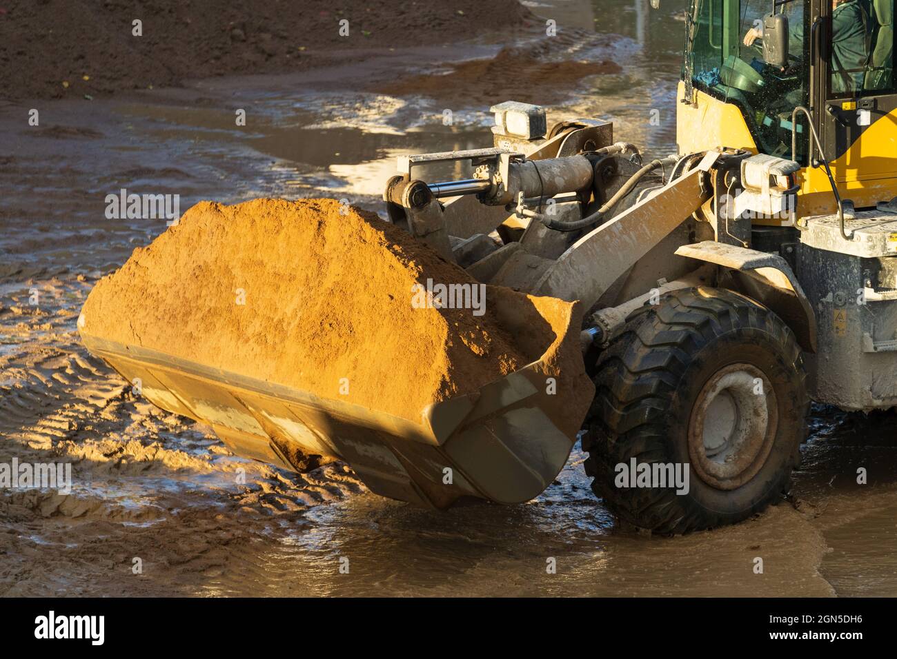 Tractor front wheel loader with sand in bucket. Earthmoving works at ...