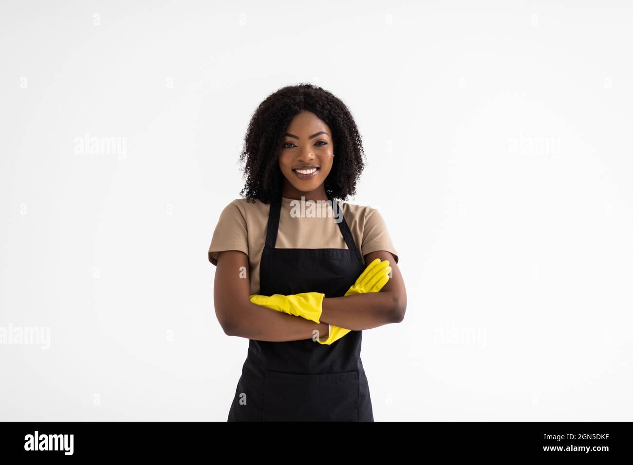 Cleaning concept. Young african woman in green apron on white ...