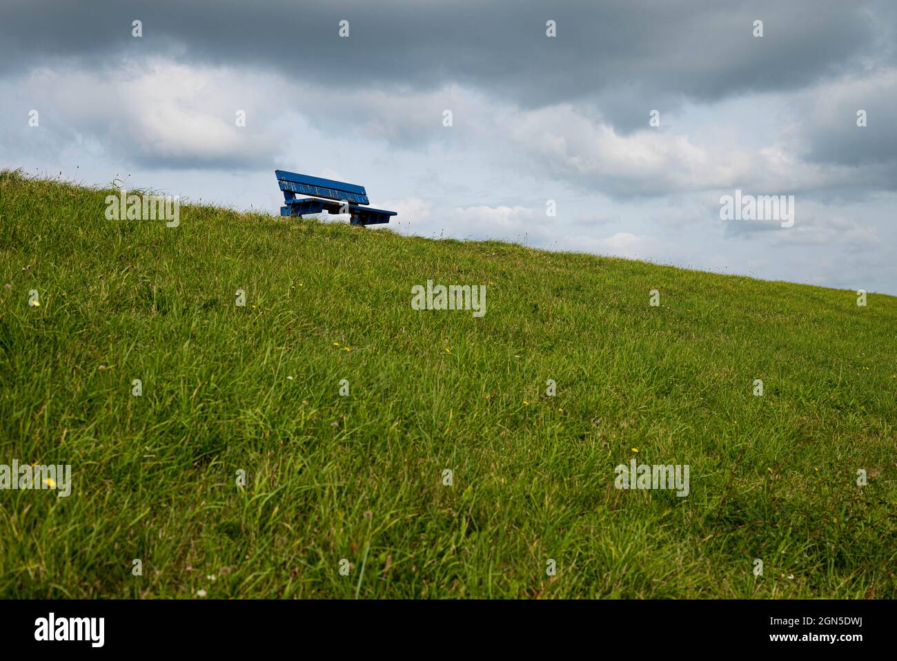 Still life picture of a blue bench on the dike in Petten (The ...