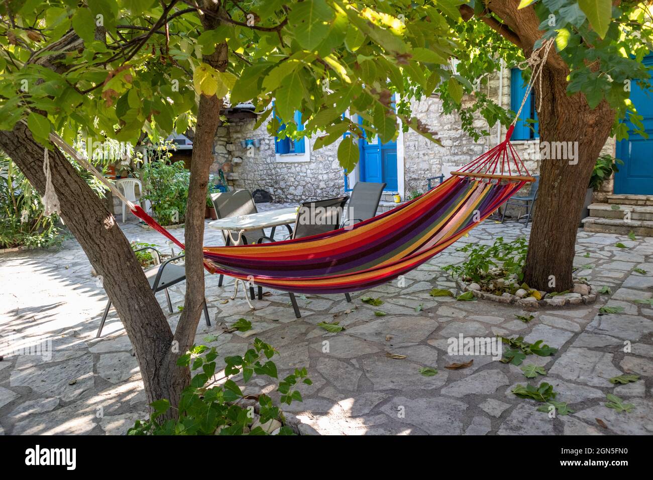 Colorful hammock and recreation zone with sun shining through green ...