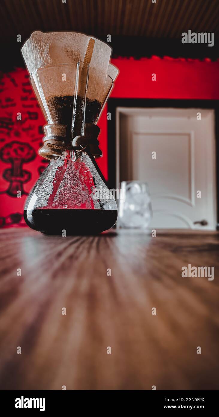 Vertical shot of filtered coffee brewing in a glass on the table Stock ...