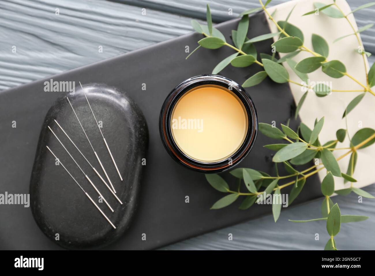 Acupuncture needles and spa stone on table Stock Photo - Alamy