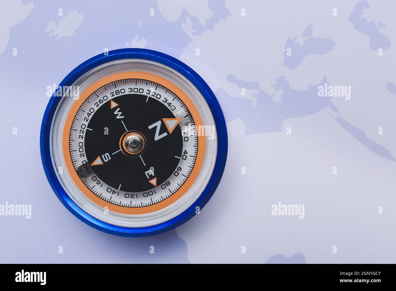 Compass on world map, top view Stock Photo - Alamy