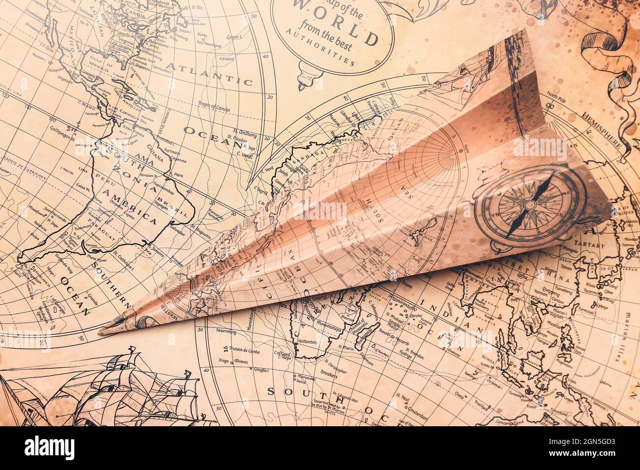 Paper airplane on vintage world map Stock Photo - Alamy