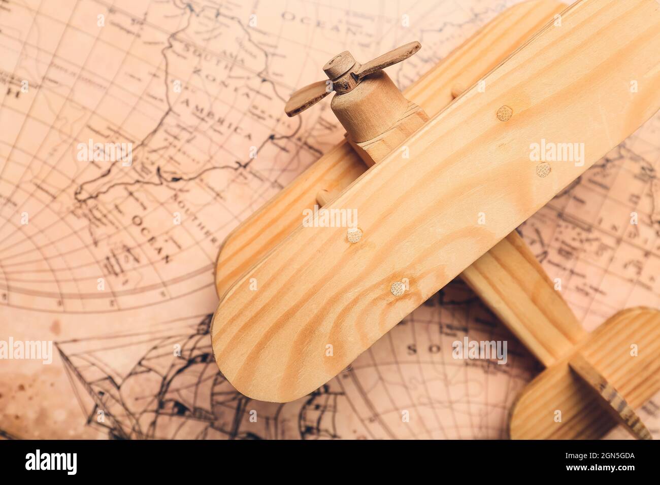 Wooden airplane on vintage world map Stock Photo - Alamy