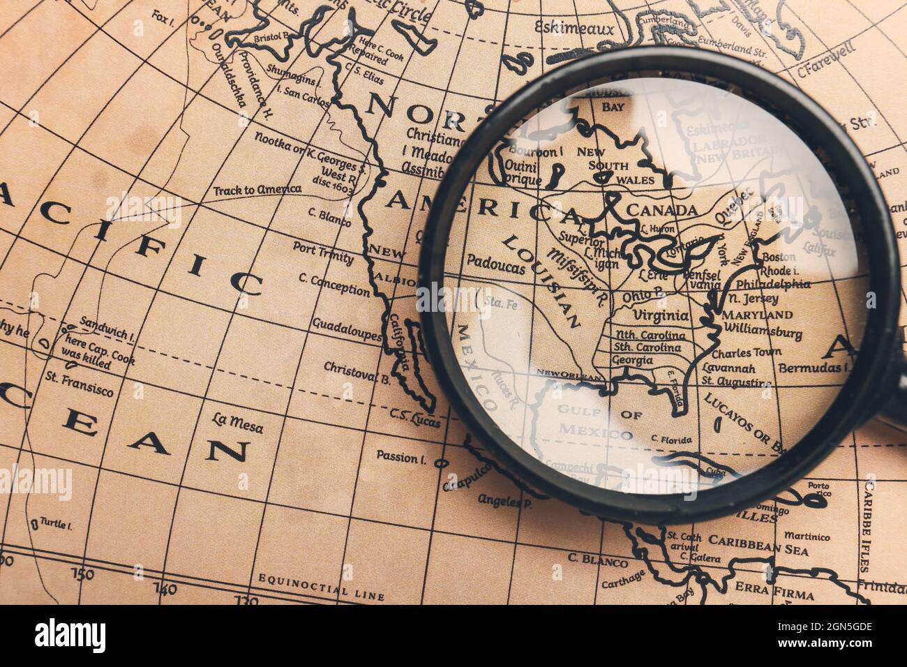 Magnifier on vintage world map Stock Photo - Alamy
