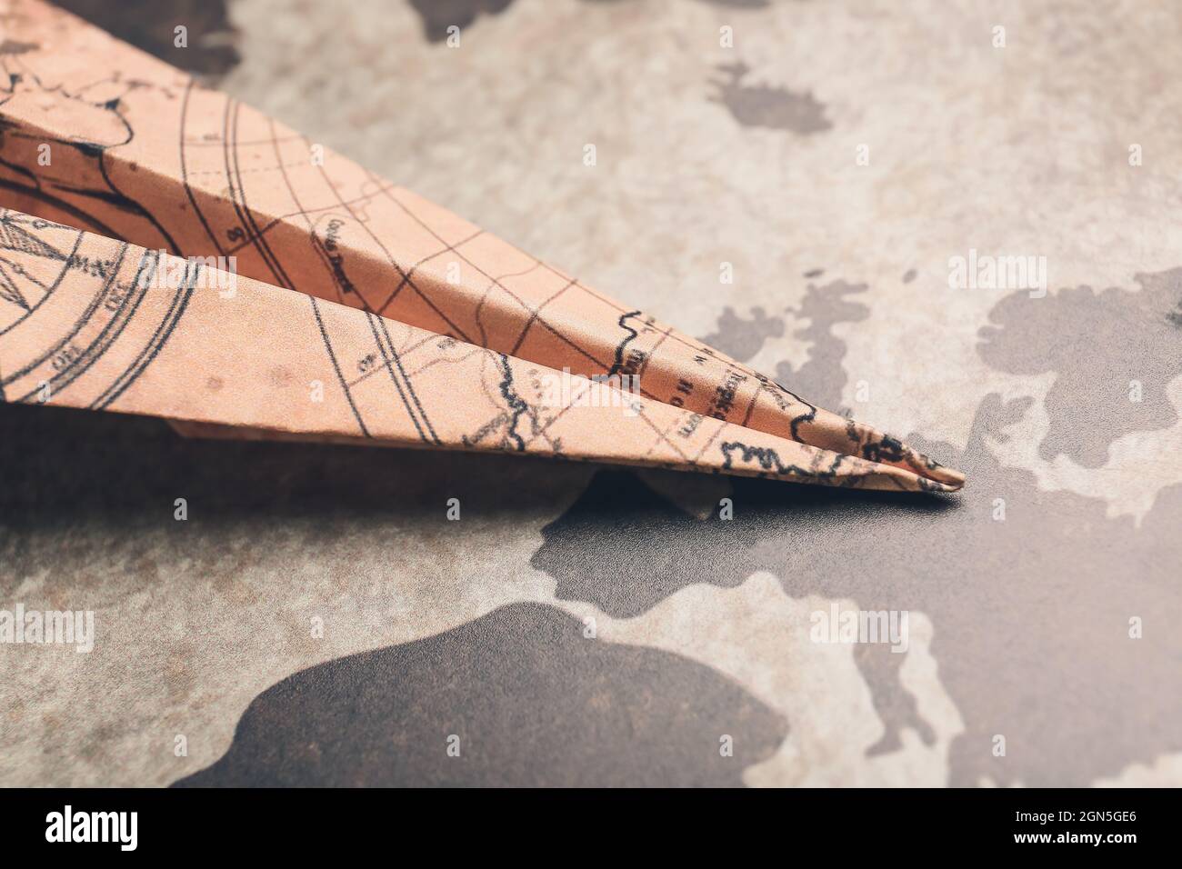 Paper airplane on vintage world map, closeup Stock Photo - Alamy