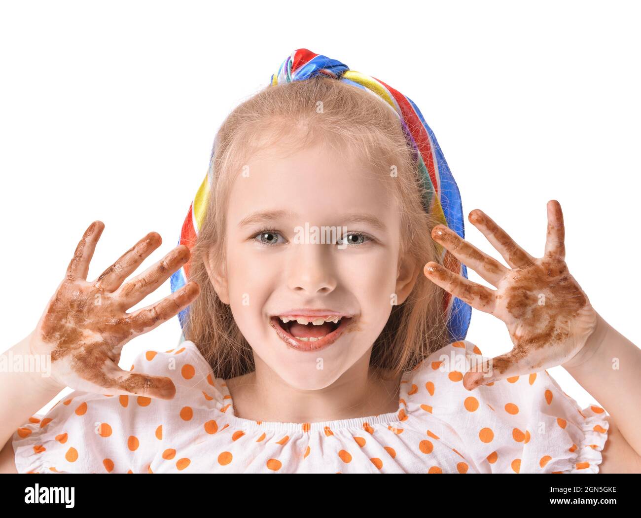 Cute little girl with chocolate on her hands and face against white ...