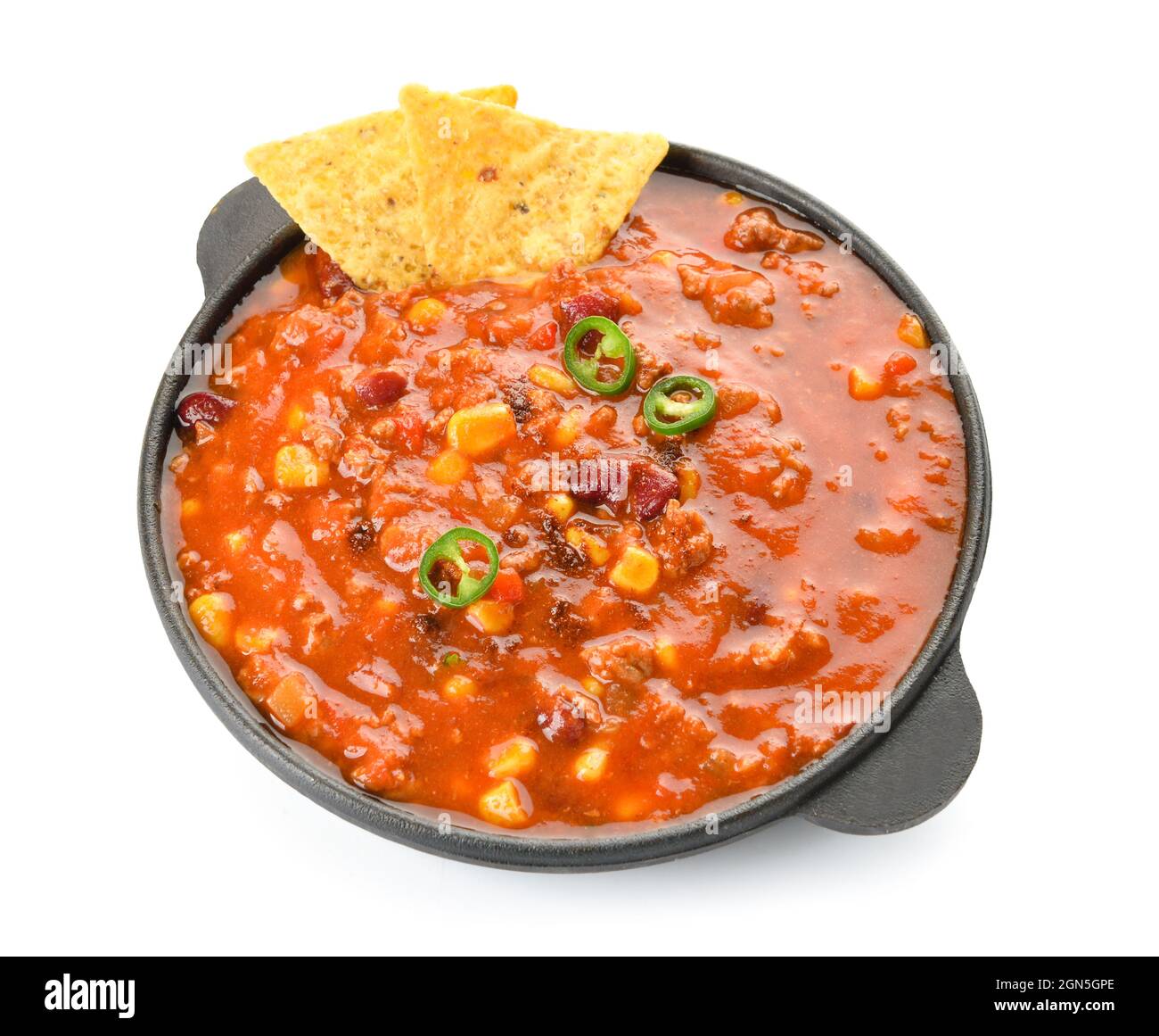 Frying pan with delicious chili con carne and nachos on white ...