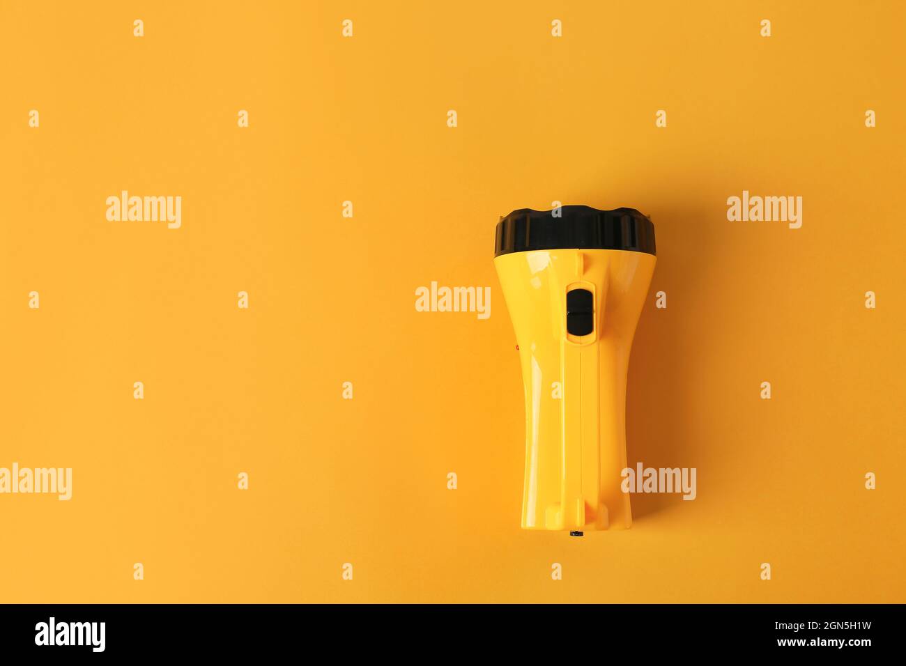 Modern flashlight on color background Stock Photo - Alamy