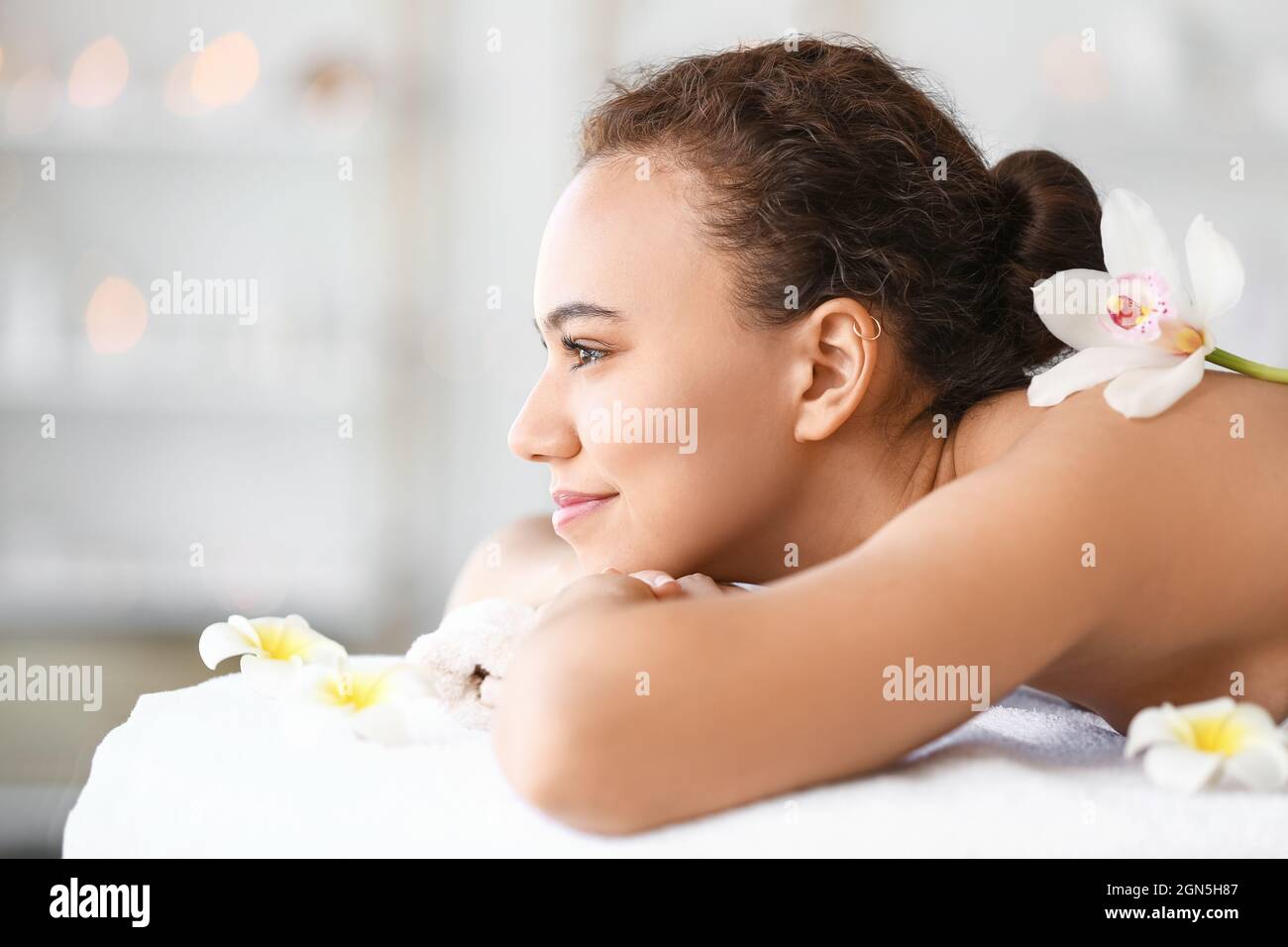 Beautiful young African-American woman relaxing in spa salon Stock ...