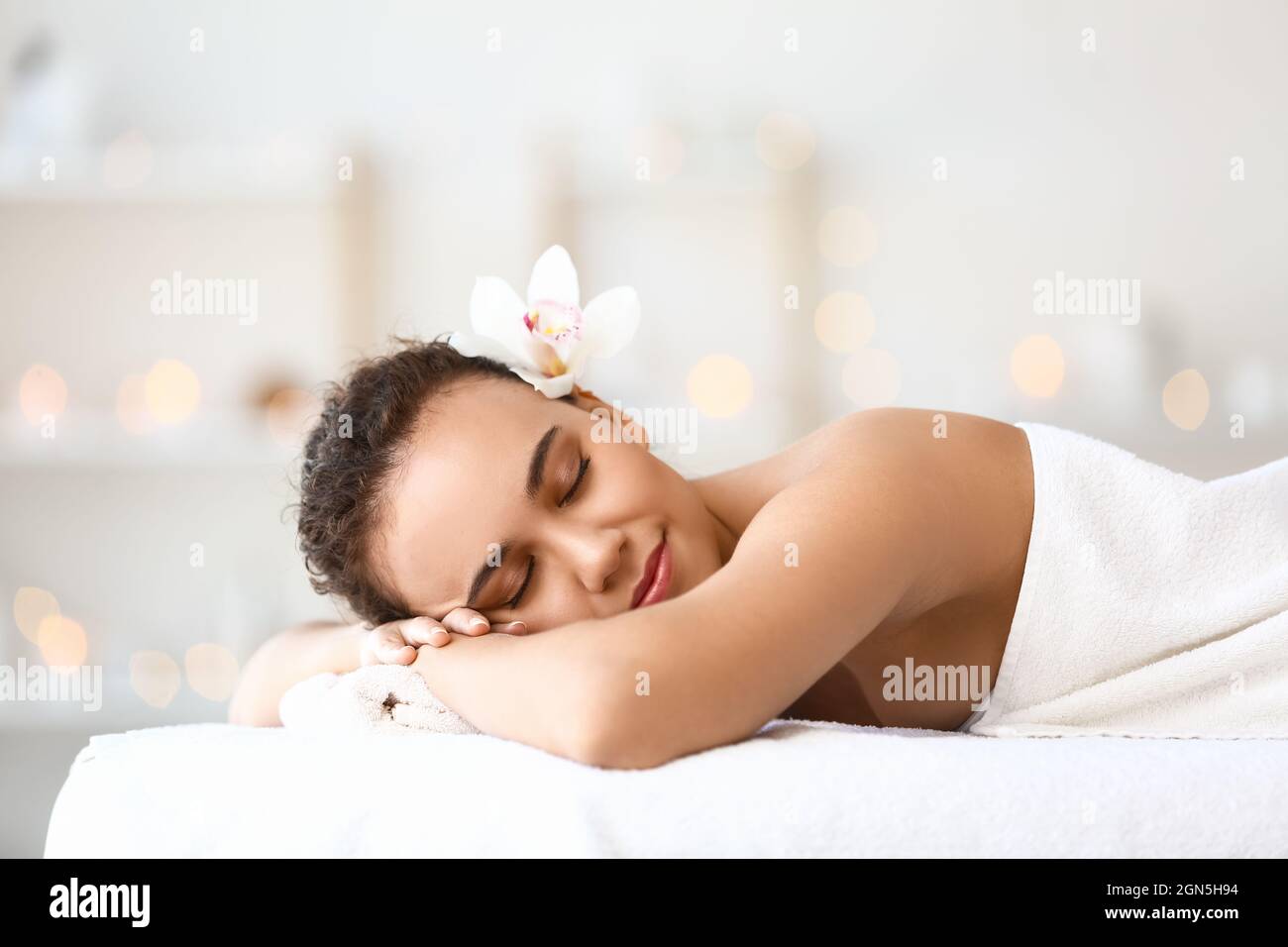 Beautiful young African-American woman relaxing in spa salon Stock ...