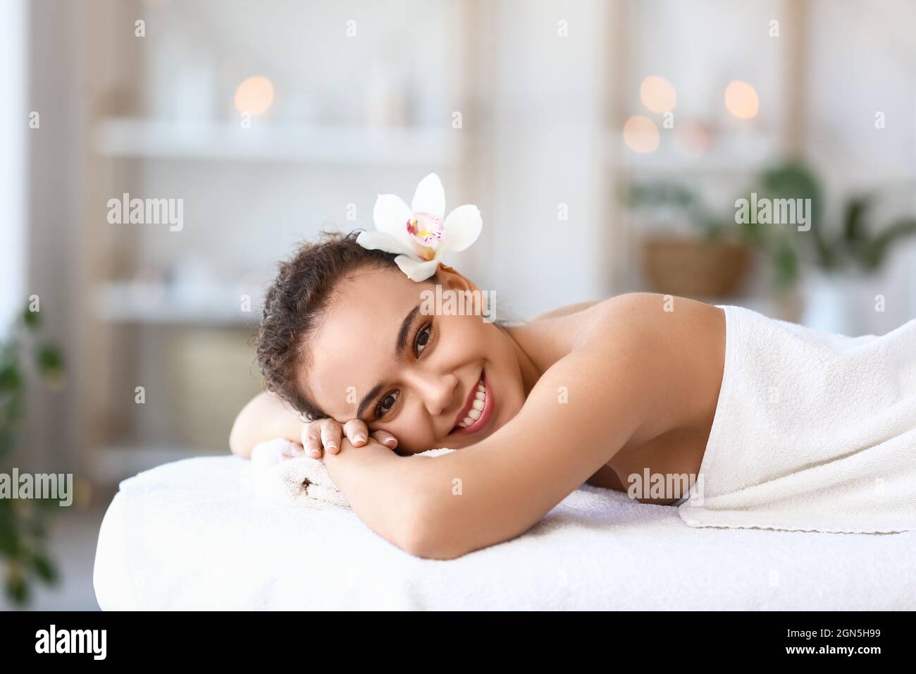 Beautiful young African-American woman relaxing in spa salon Stock ...